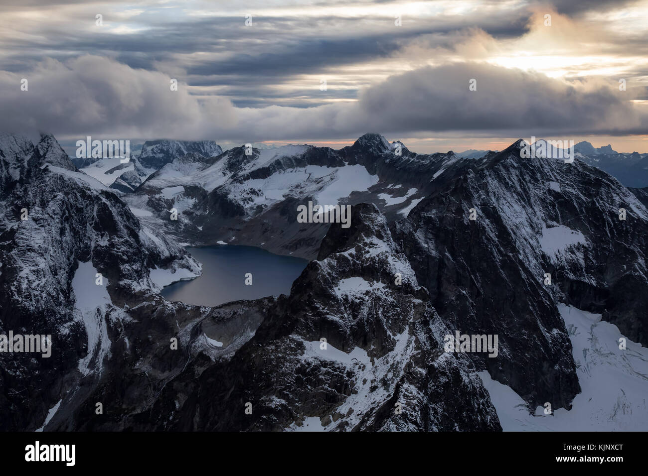 Aerial abstract landscape of the rugged mountains covered in clouds ...