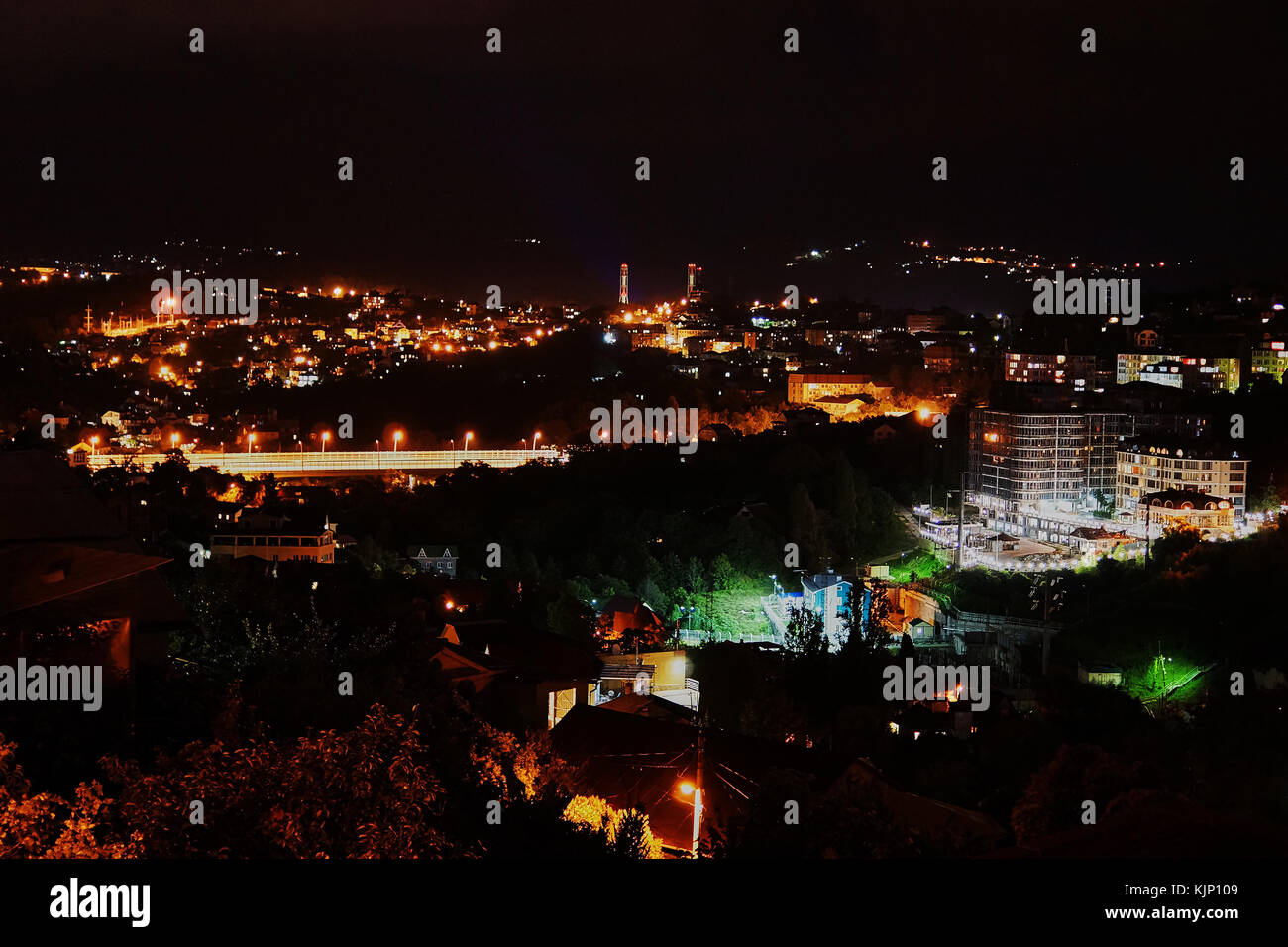 Panorama of Sochi from the air. Houses, streets, trees, the night sky ...
