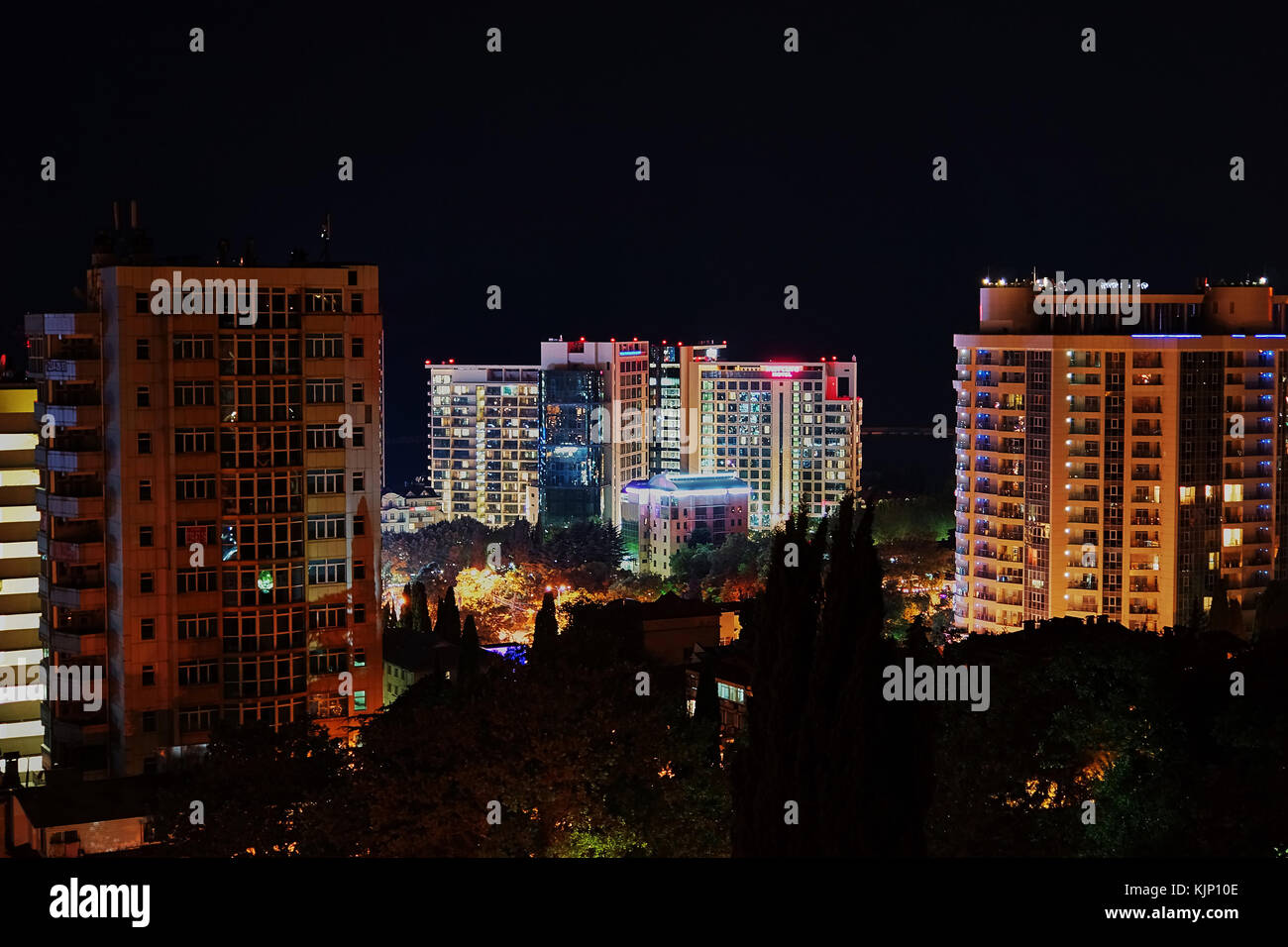 Panorama of Sochi from the air. Houses, streets, trees, the night sky ...