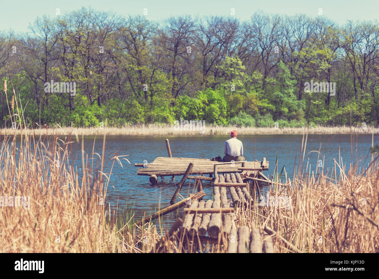 Man on summer lake Stock Photo - Alamy