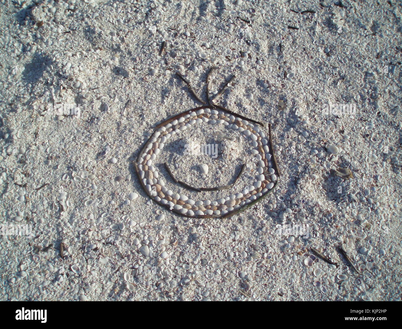Happy face draw made of shells on Sanibel Island beach Stock Photo - Alamy