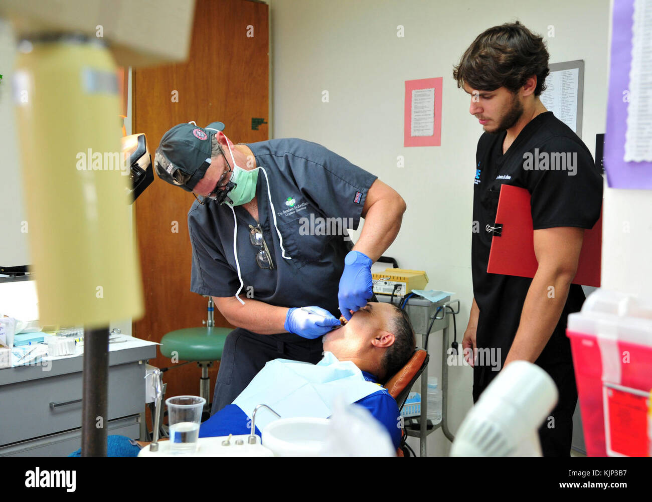 Dentist observes hi-res stock photography and images - Alamy