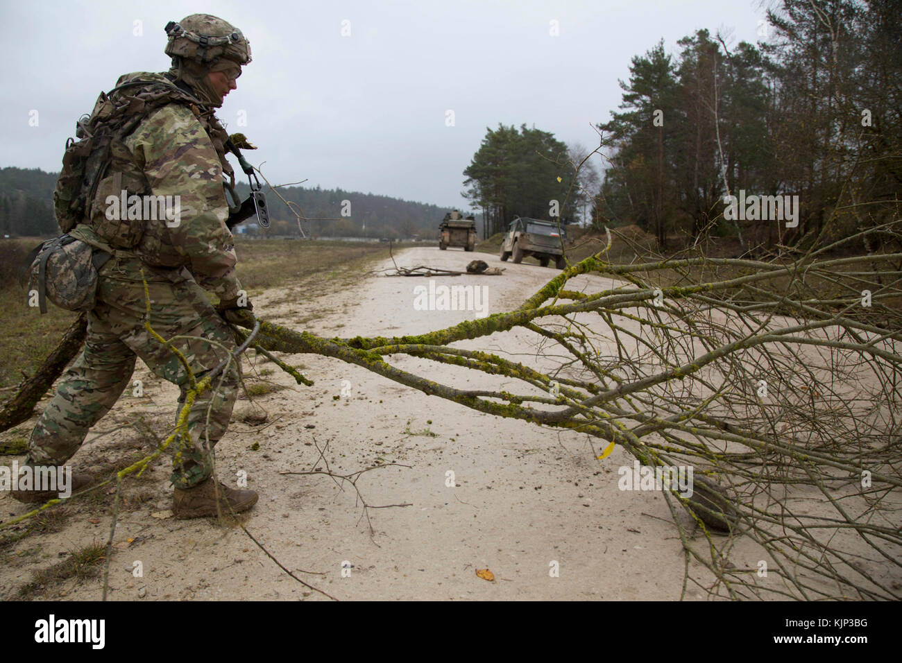 A U.S. Soldier of 2nd Cavalry Regiment places a roadblock while ...