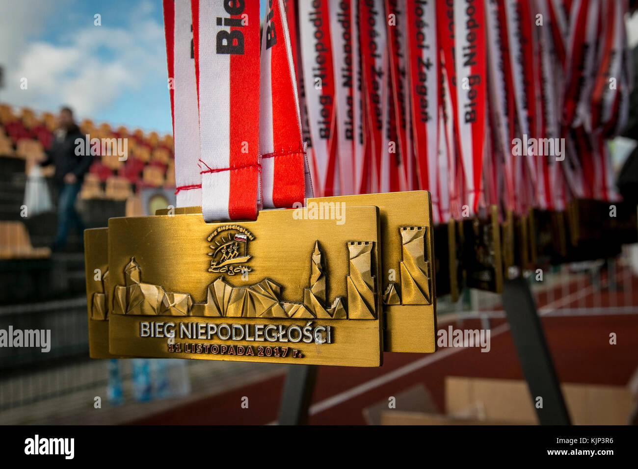 Medals are lined up waiting for runners who cross the finish line of ...