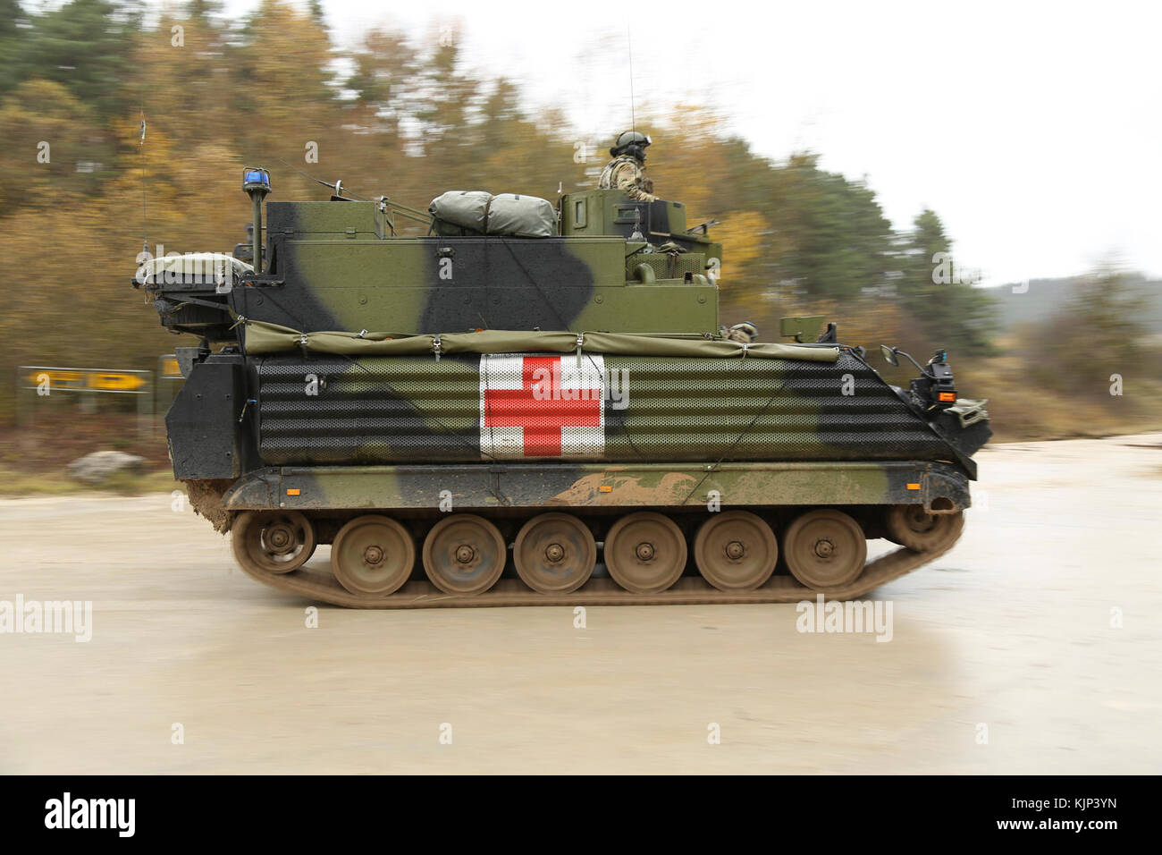 A U.S. Army Armored Personnel Carrier passes through a checkpoint ...
