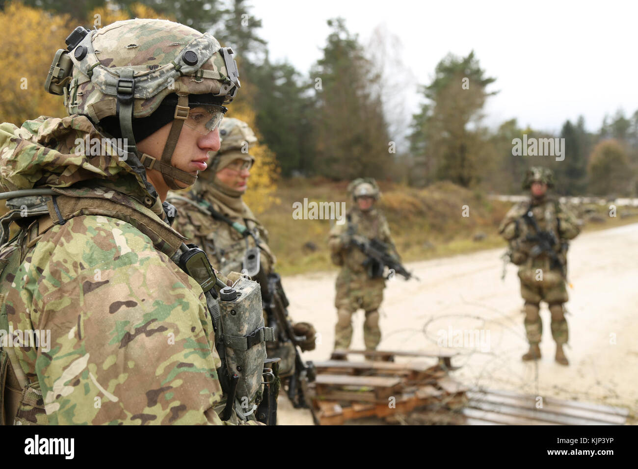U.S. Army Soldiers stand guard at a road checkpoint during exercise ...