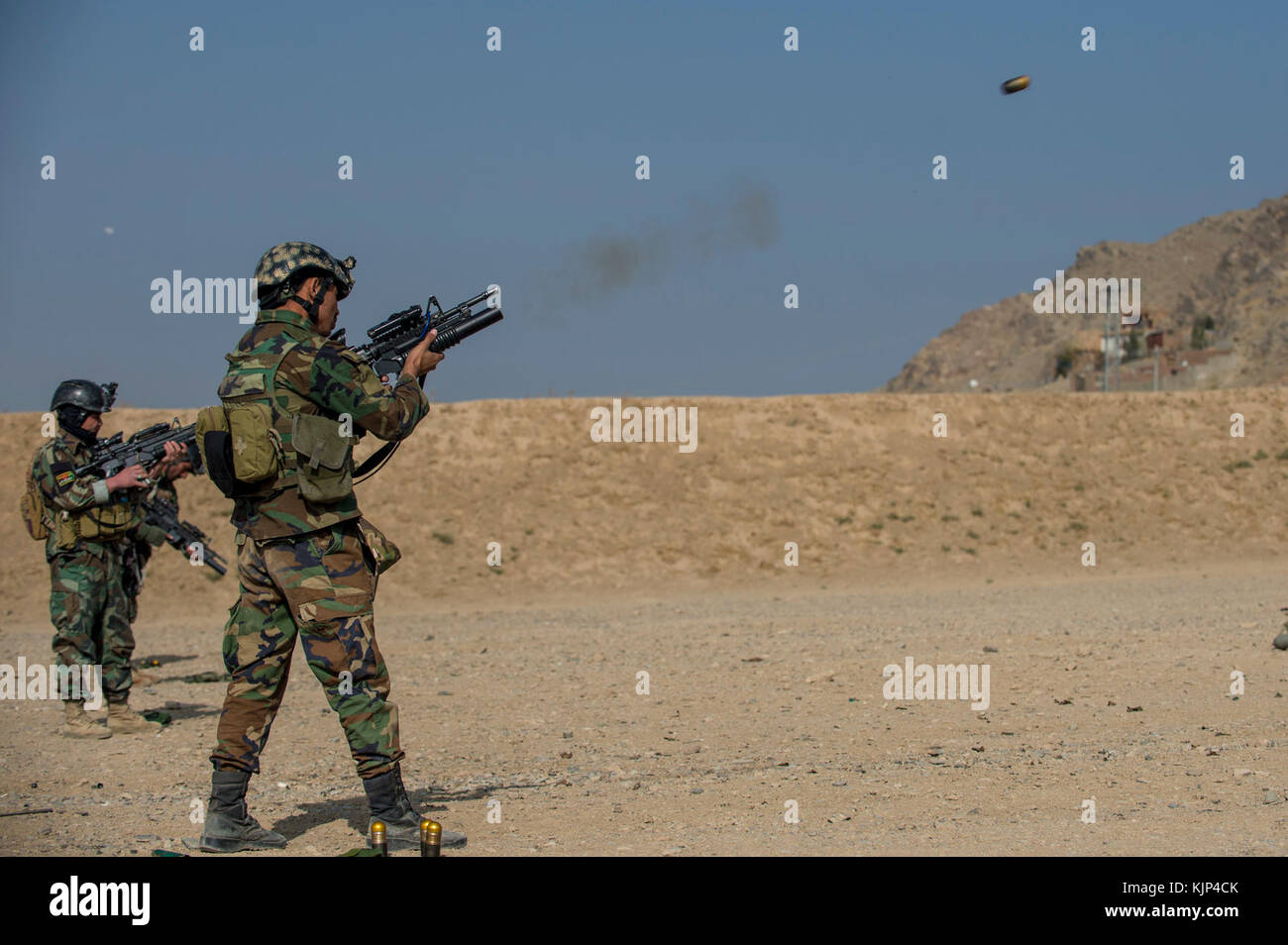 An M203 round leaves the barrel of an Afghan Commando's grenade ...
