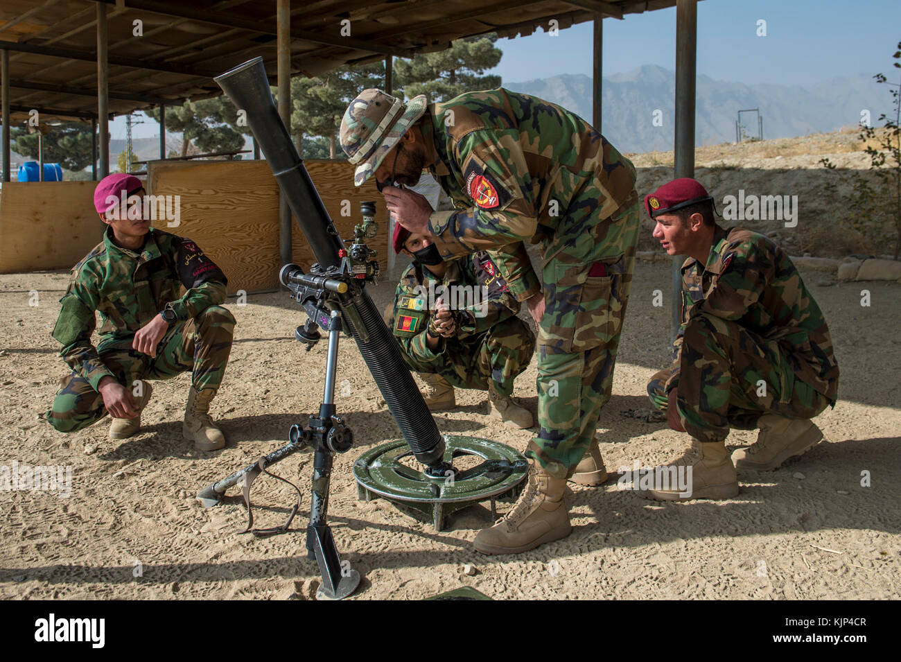 An Afghan Commando instructor checks mortar settings during Commando ...