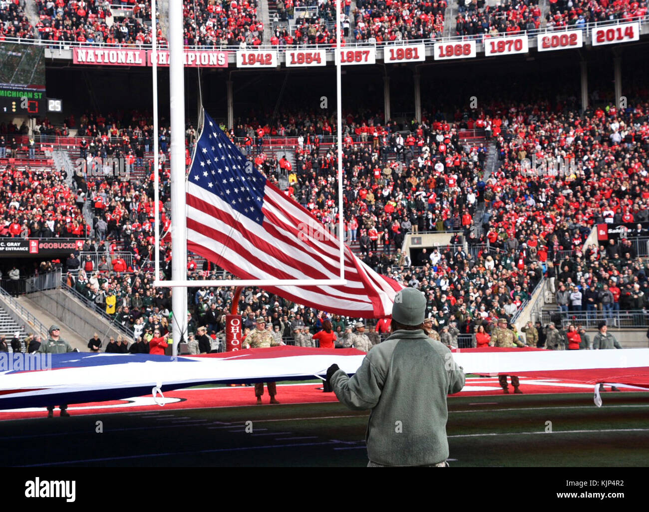 Members of the Ohio Army and Air Force National Guard present the flag ...