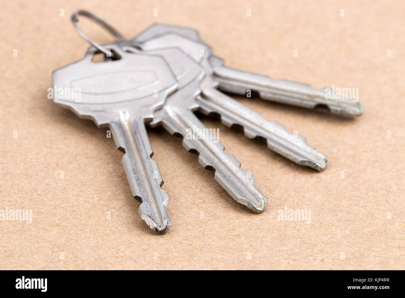 Old silver-color metal keys with key chain on wooden background Stock ...
