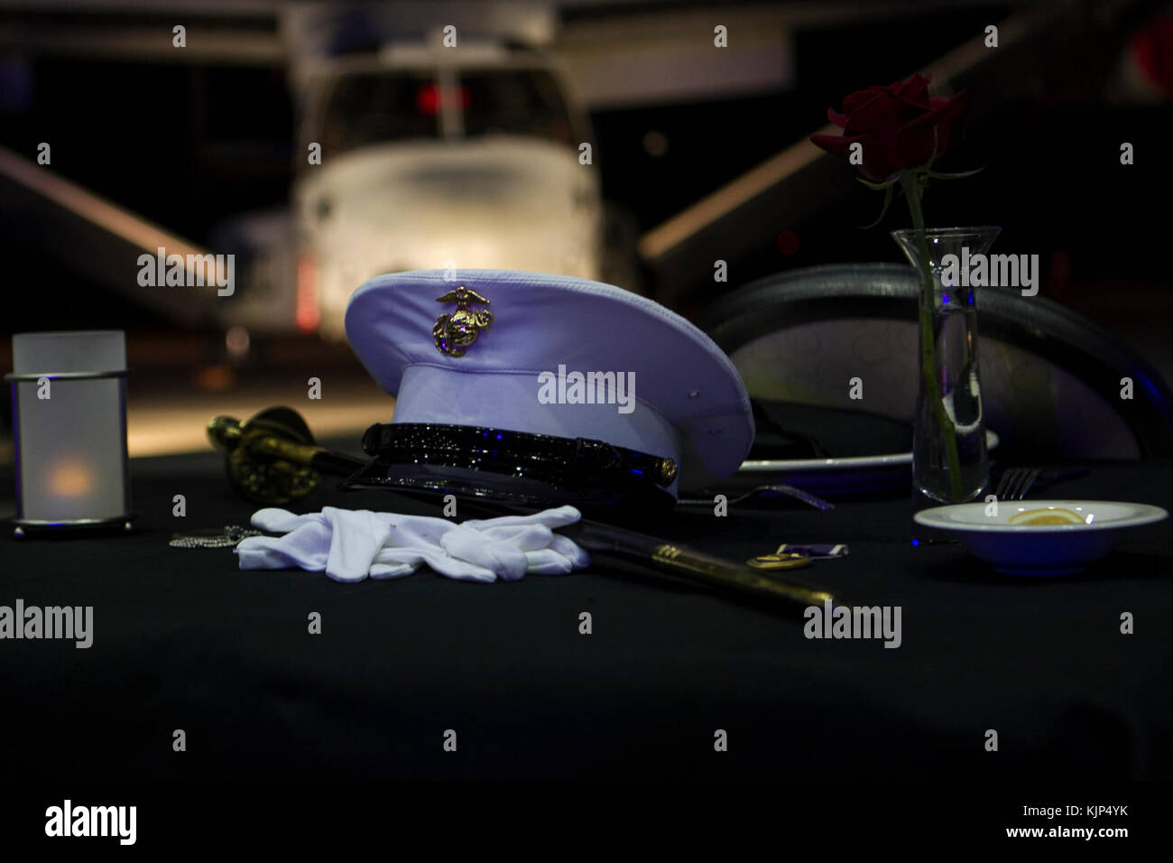A table display in honor of fallen comrades sits staged inside a hangar ...