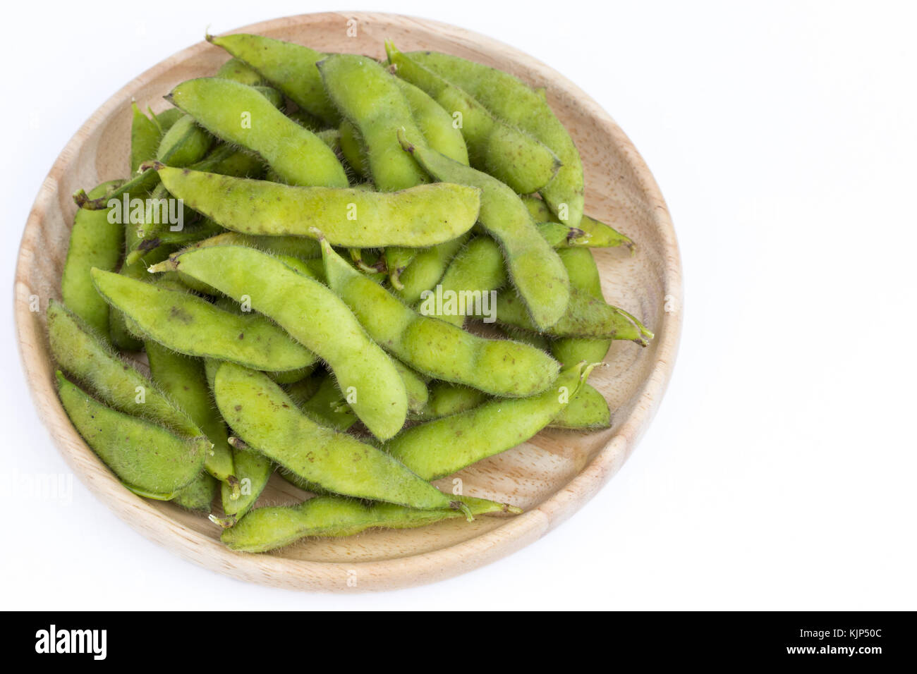Green soybean (Vegetable soybean) boiled in wooden plate on white ...