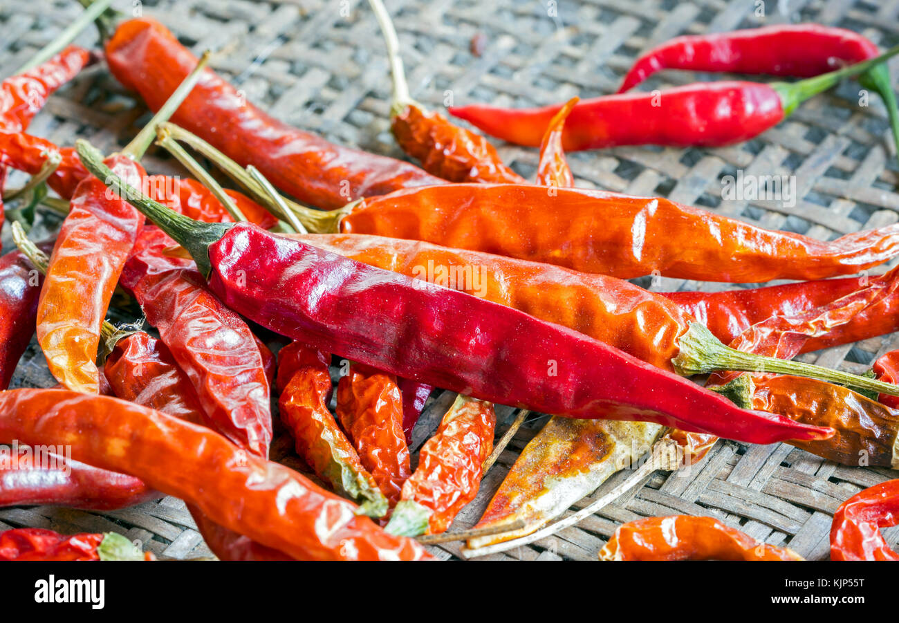 Sun-dried chilli on brown bamboo plate Stock Photo - Alamy