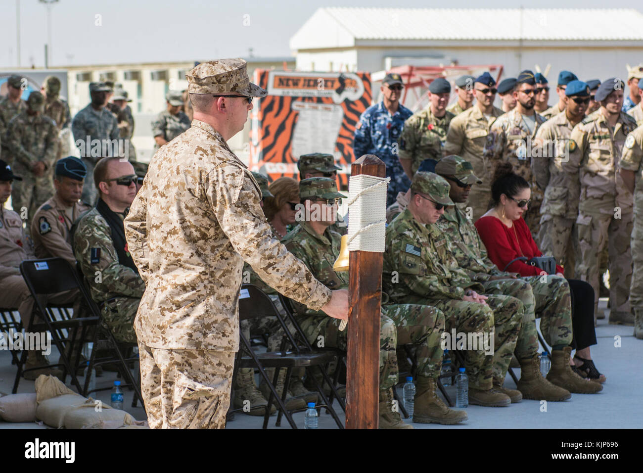 A U.S. Navy corpsman rings a bell during a moment of silence for a ...