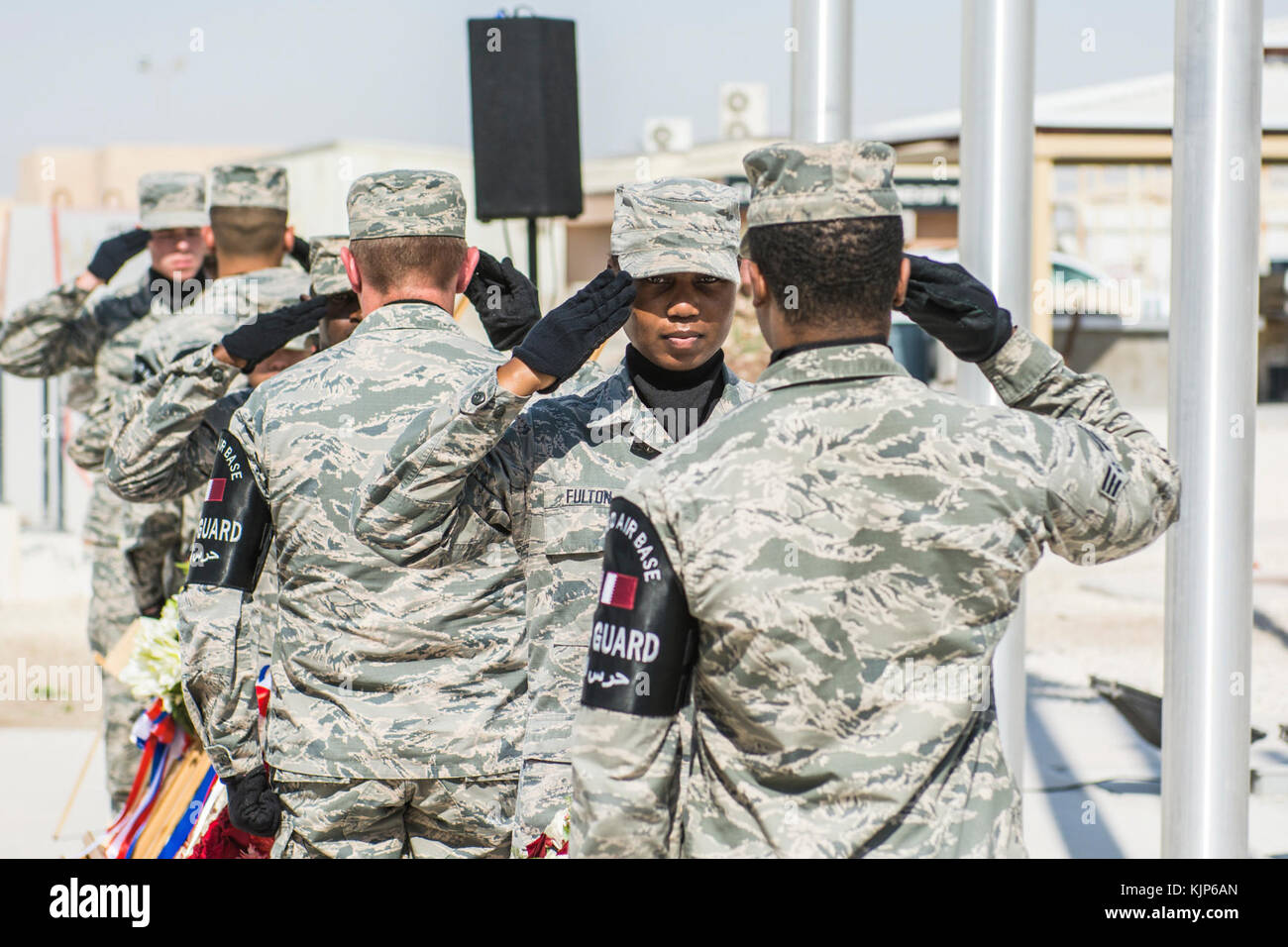 U.S. Airmen with the Al Udeid Air Base Honor Guard salute during the ...