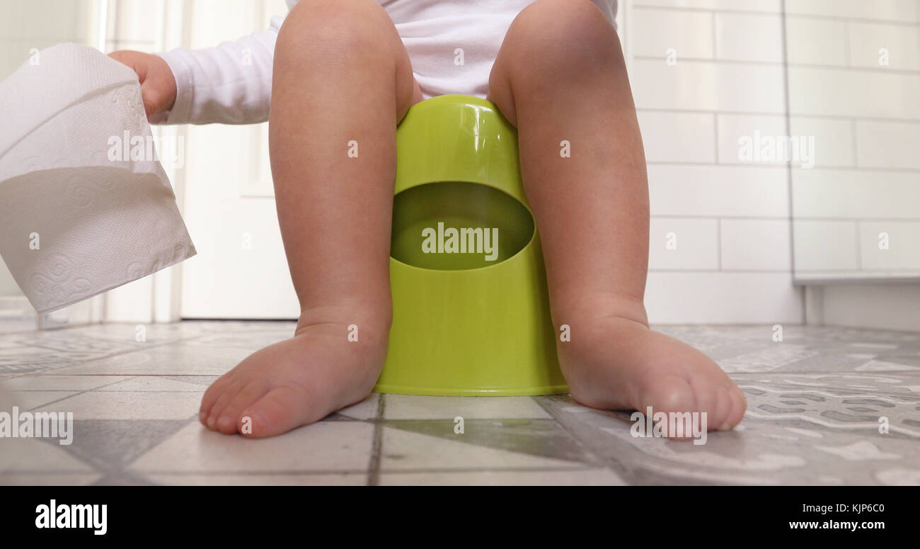 Baby sitting chamberpot his legs hanging down pot Stock Photo - Alamy