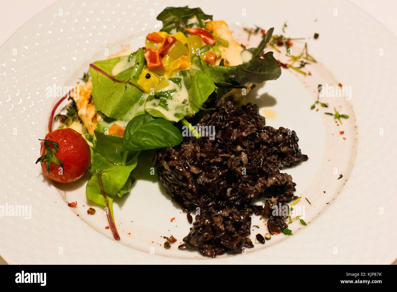 Braised black rice with the vegetables and rucola Stock Photo - Alamy