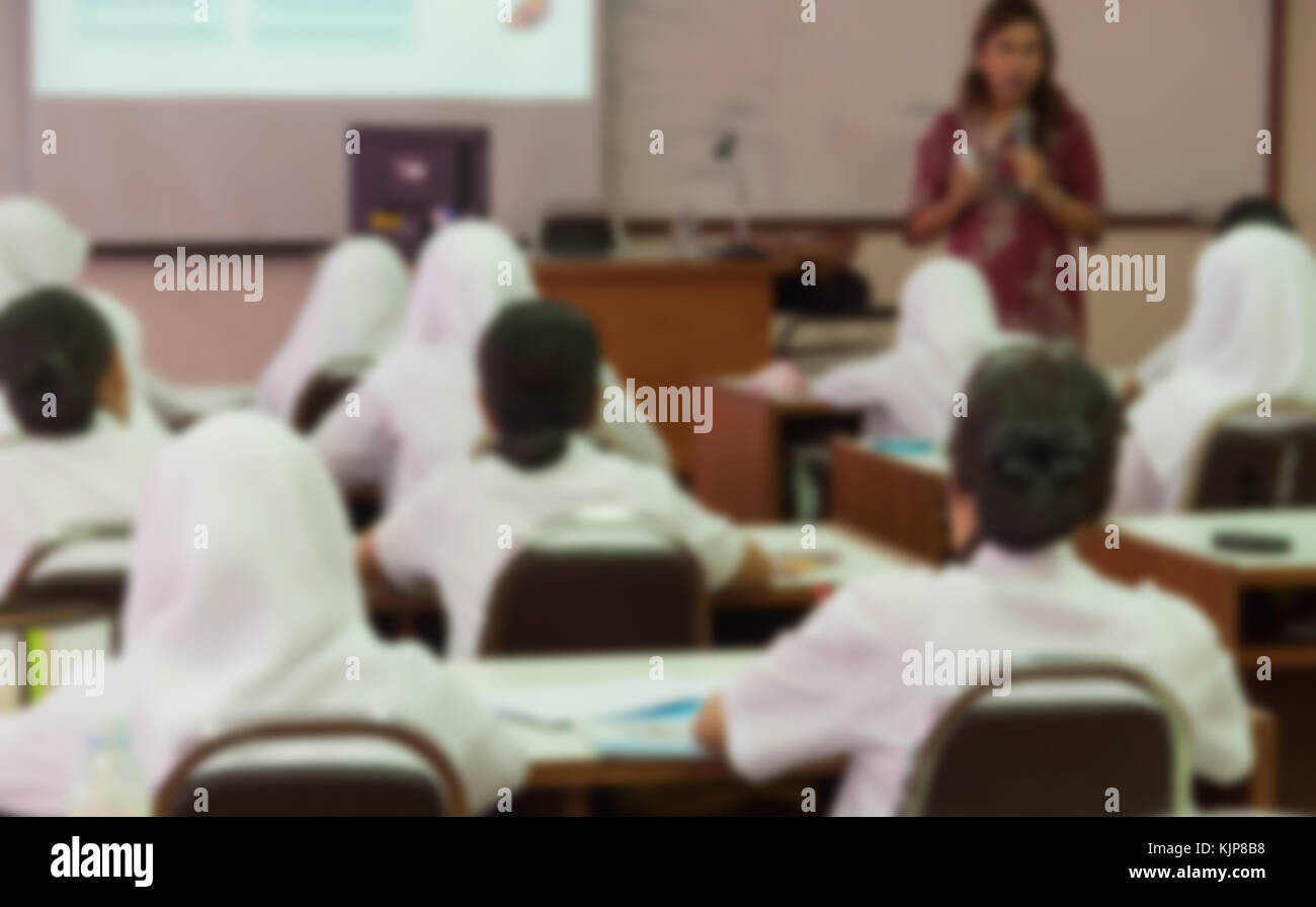 Blurred abstract background of university students sitting in a lecture ...