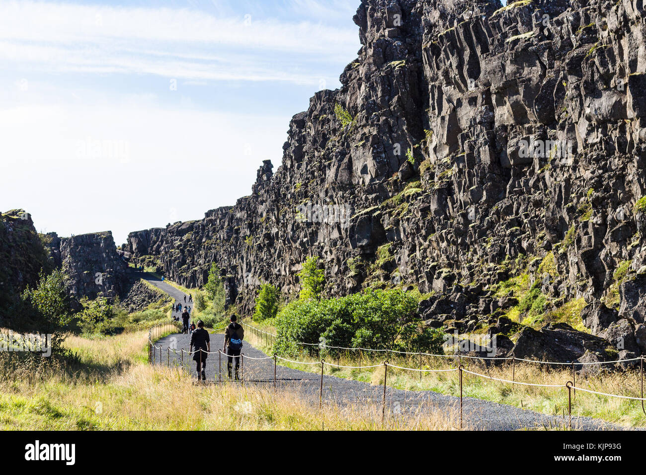 THINGVELLIR, ICELAND - SEPTEMBER 6, 2017: visitors walk to Almannagja ...