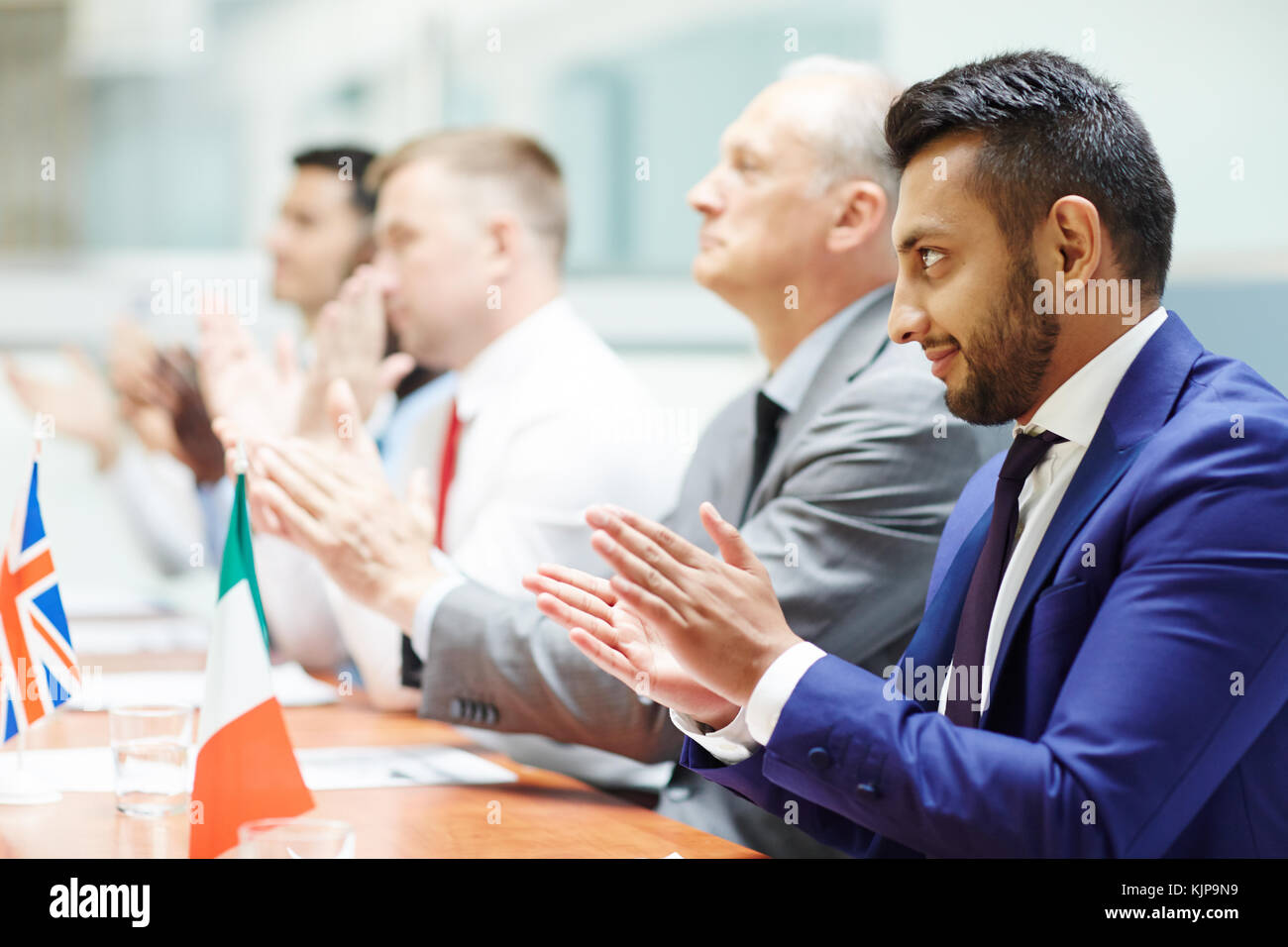 Group of politicians congratulating speaker by ovations after making ...