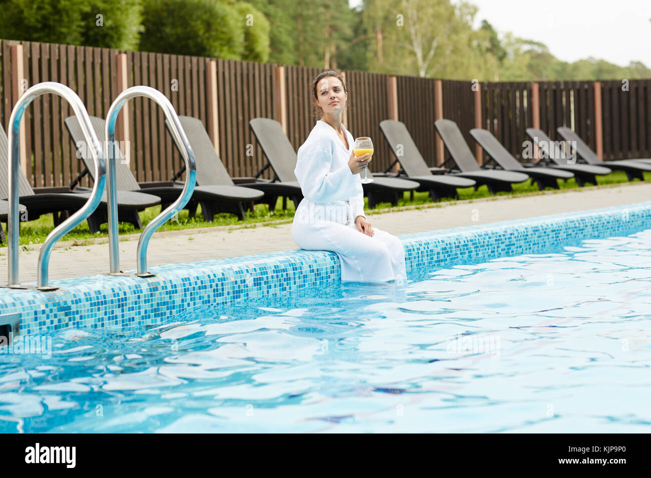 Young woman with juice enjoying her solitude at spa resort Stock Photo ...