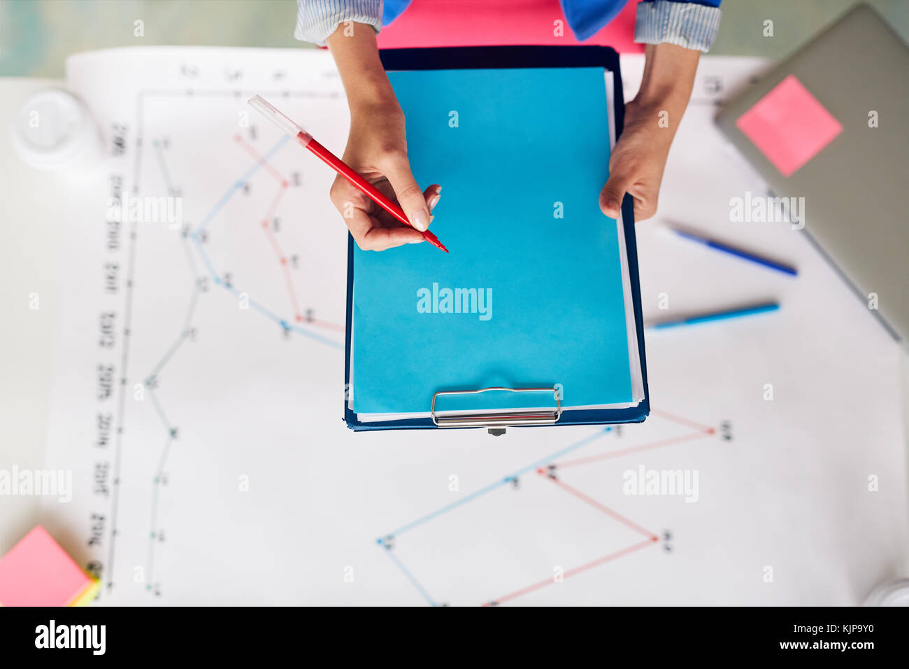 Secretary making financial notes on blue paper during presentation ...