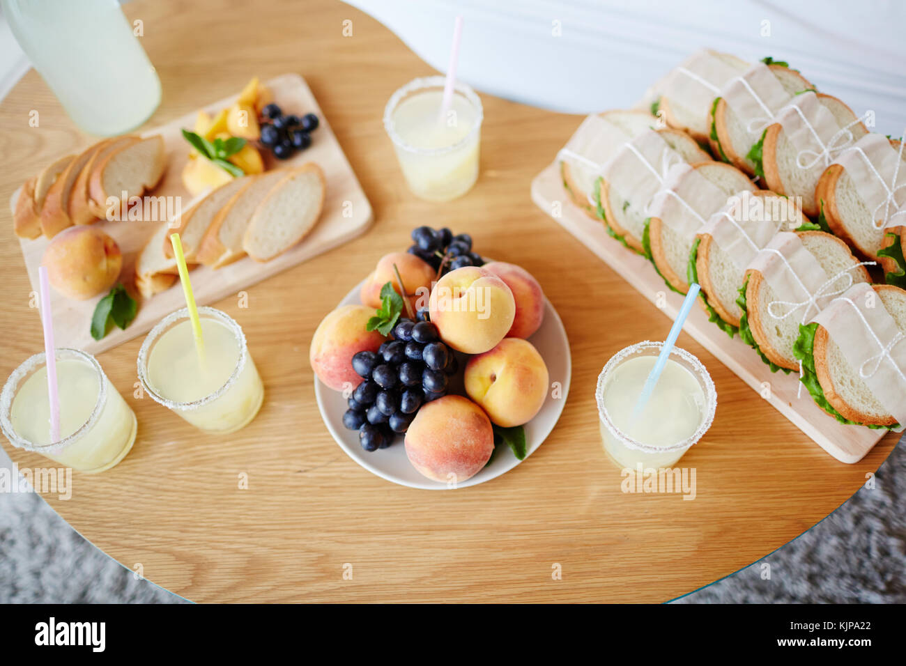 Tasty snack and drinks served for guests on wooden table Stock Photo ...