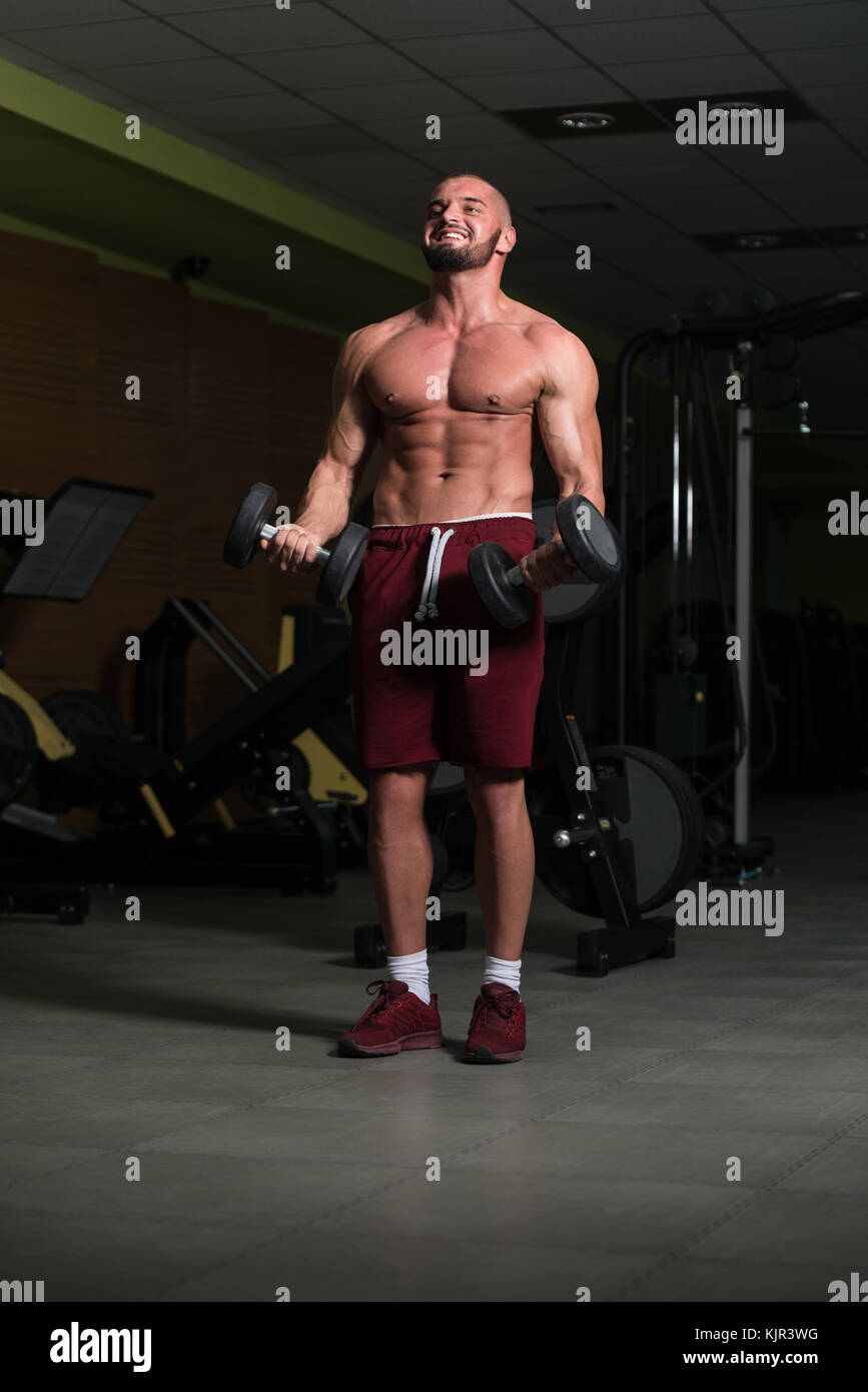 Man Working Out Biceps In A Gym - Dumbbell Concentration Curls Stock ...