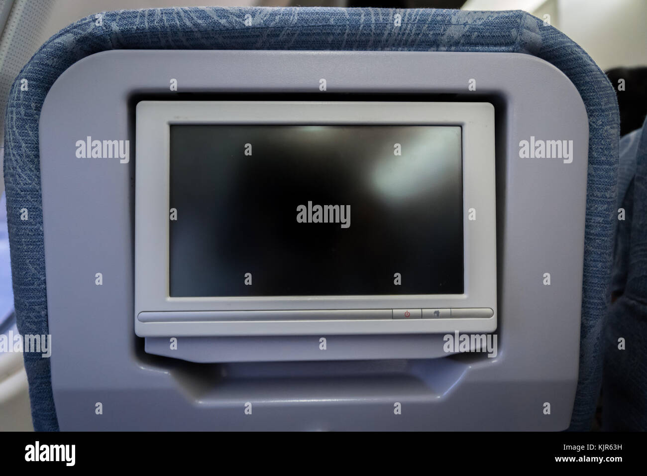 in-flight entertainment system screen of economy class seat on airplane ...