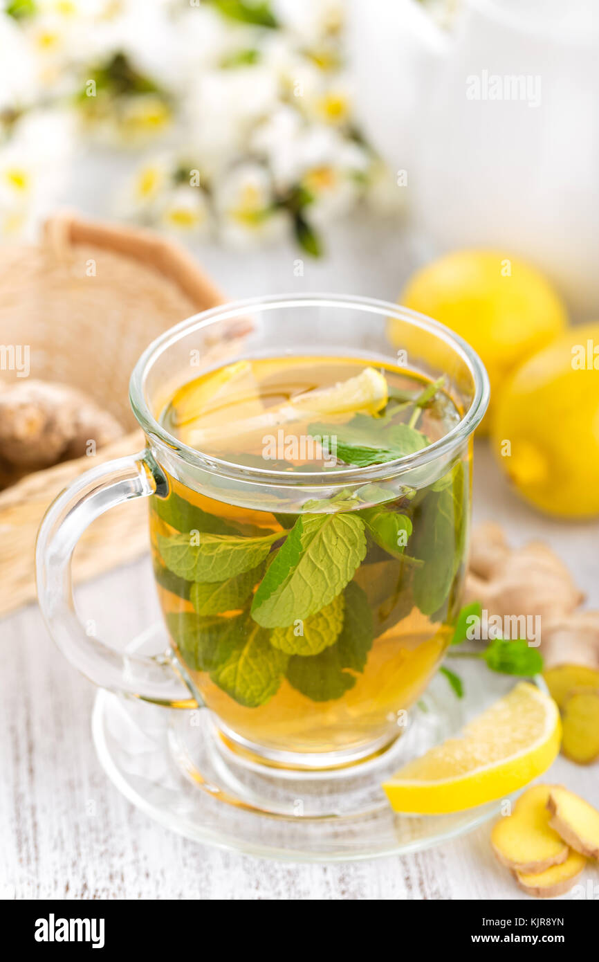 Flavored herbal tea with fresh lemon, ginger and mint leaves on white ...