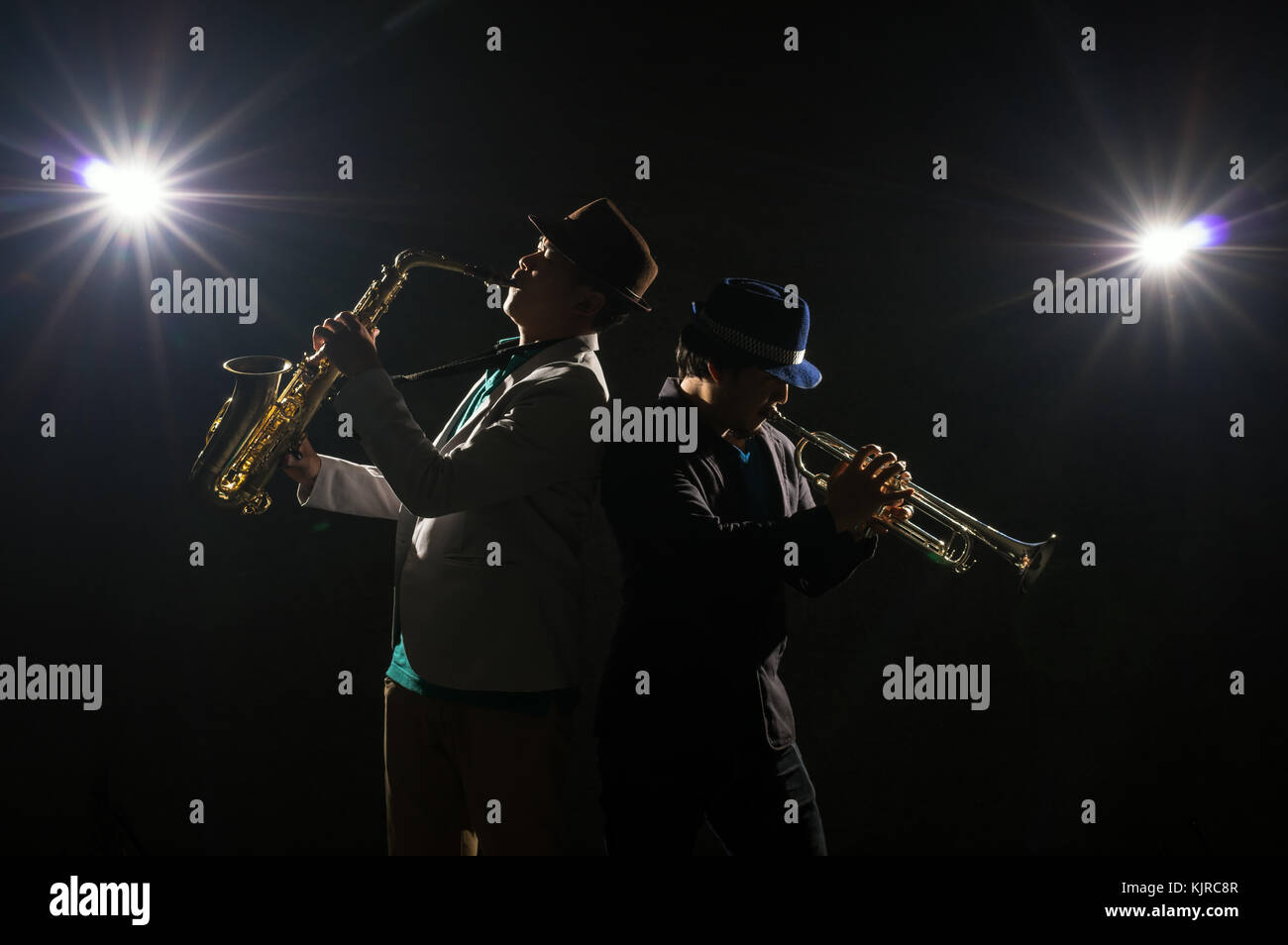 Musician Duo band playing the Trumpet with spot light and lens flare on ...