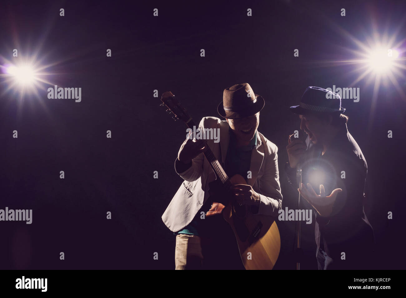 Musician Duo band hand holding the microphone and singing a song and ...