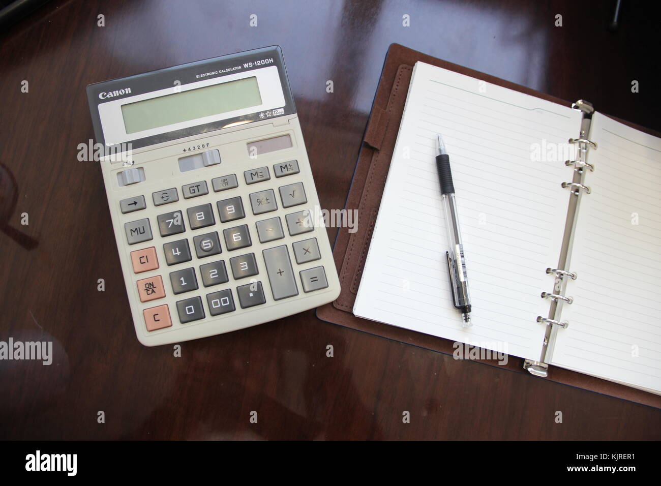 Calculator and notebook Stock Photo - Alamy