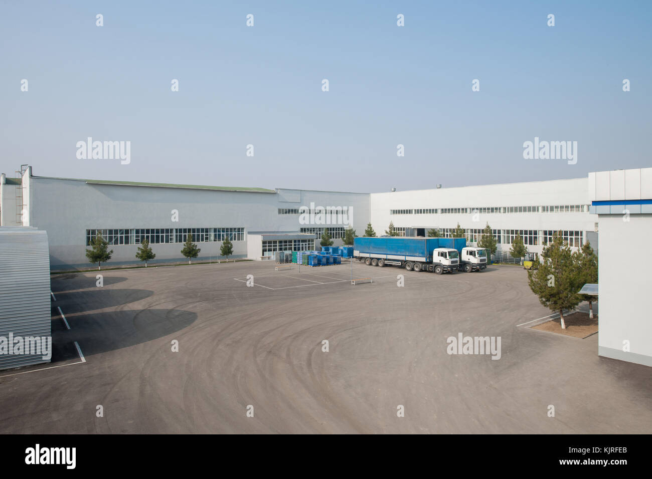 general view of the factory with trucks. a truck in the parking lot of ...