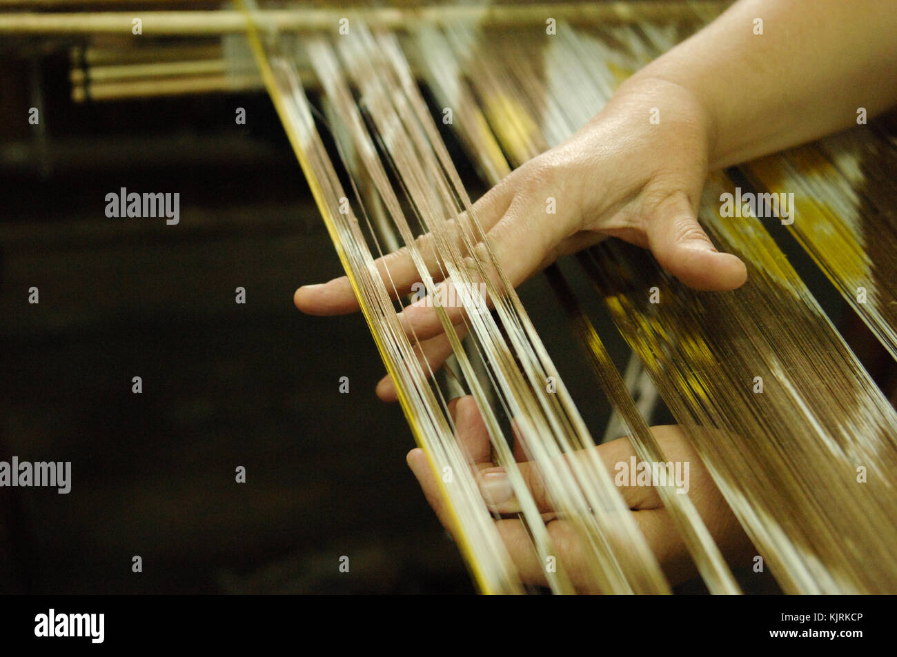 weaving and manufacturing of handmade fabric close up. women's hands ...