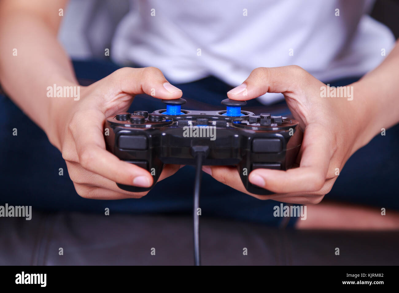 Close up of hand playing the video game with a joystick Stock Photo - Alamy