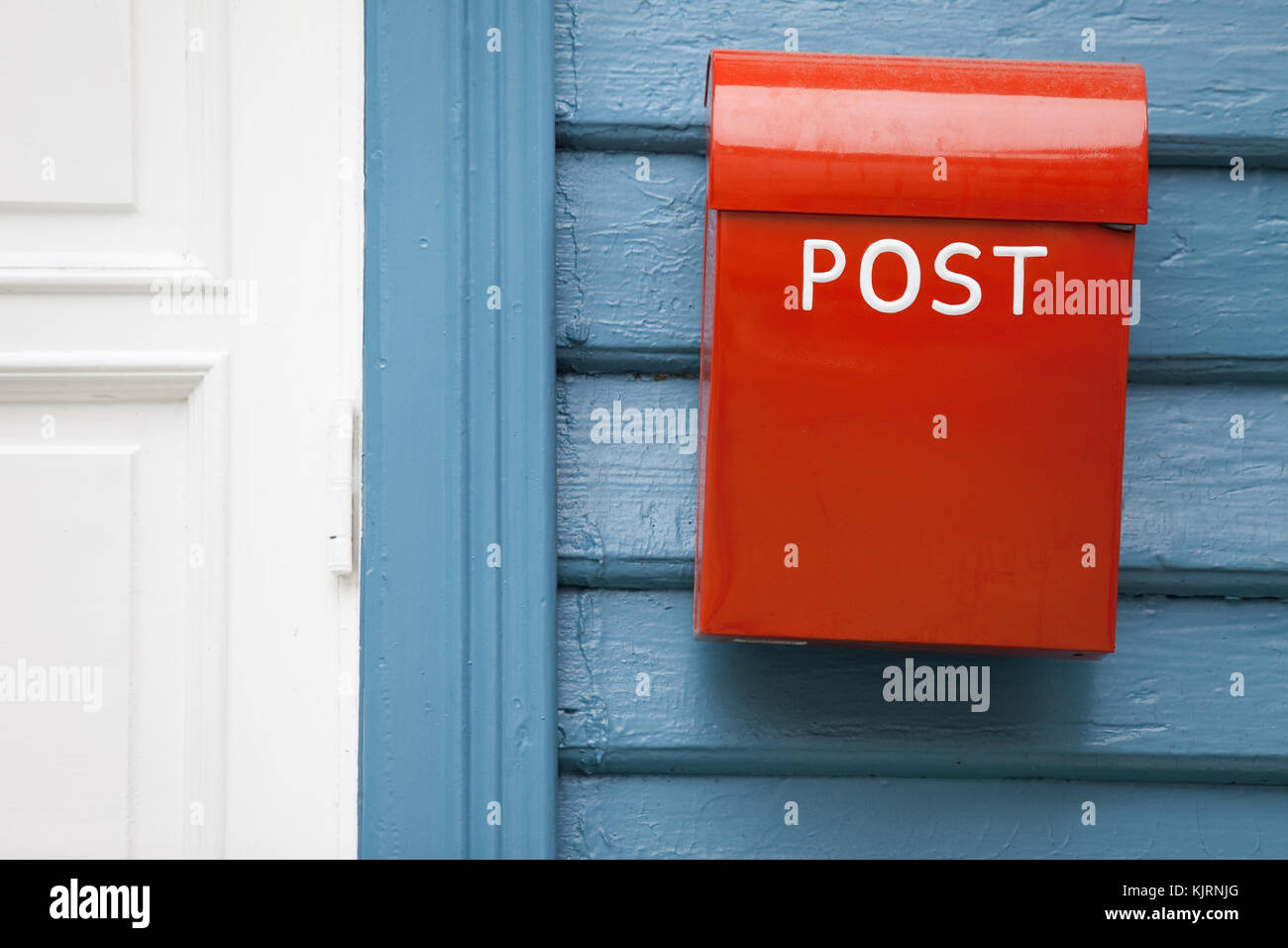 A red letter box at a wooden house Stock Photo - Alamy