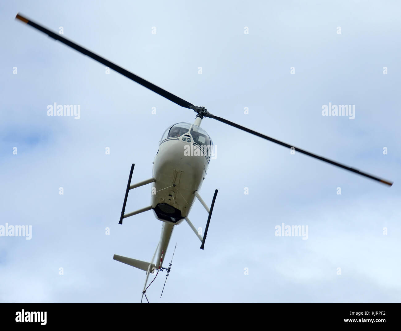 Light helicopter in flight seen from below Stock Photo - Alamy