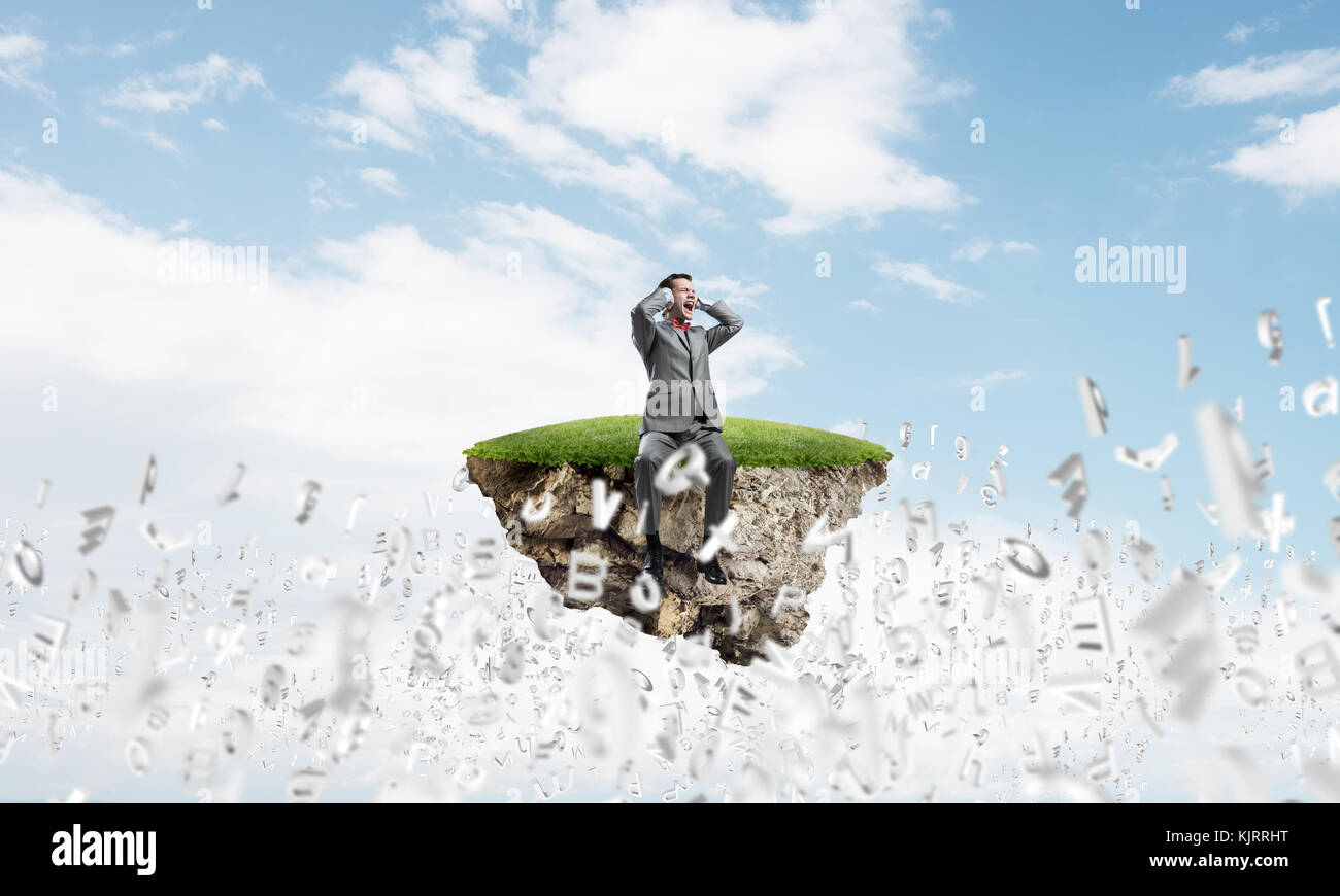 Young man floating in sky and dont want to hear anything Stock Photo ...
