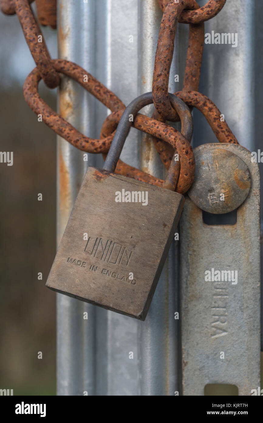 Padlock & chain securing industrial gate. For email data security ...