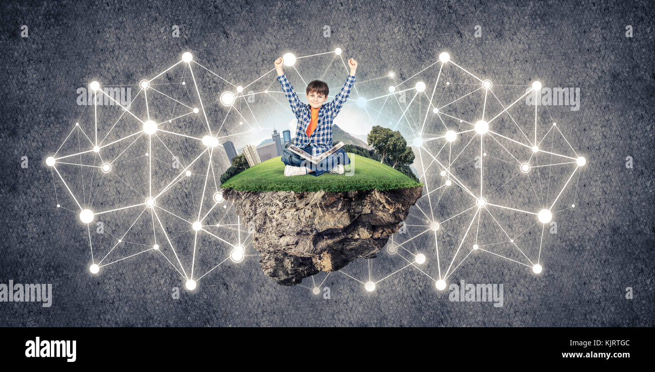 Cute boy of school age with book exploring this great world Stock Photo ...