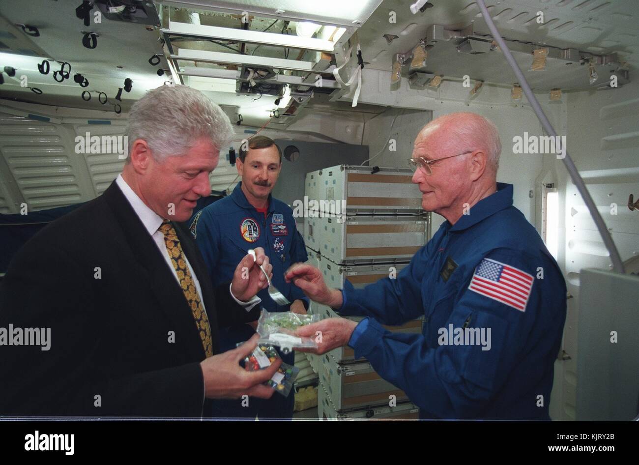 U.S. President Bill Clinton (left) samples space food while visiting ...