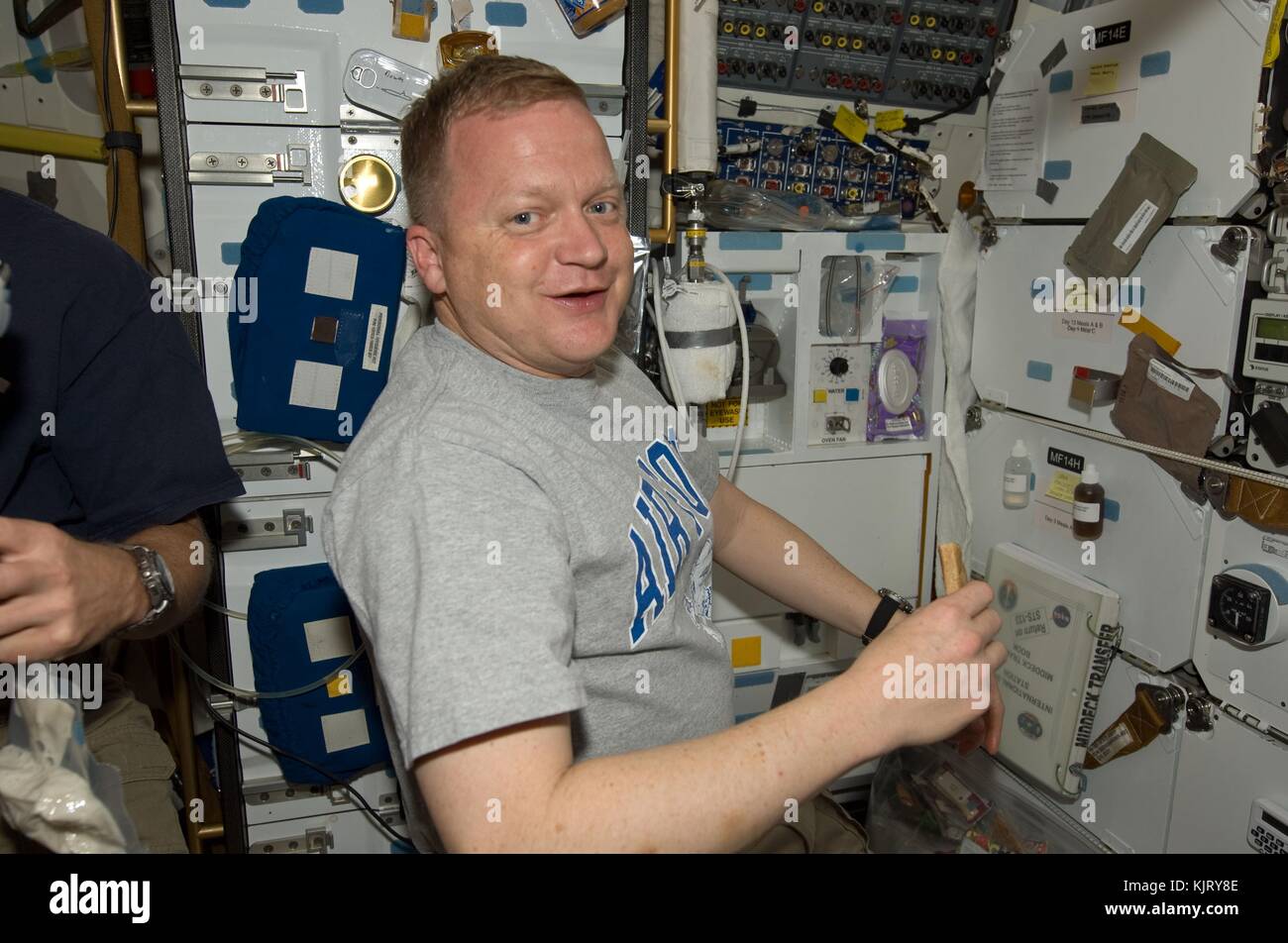 NASA STS-133 mission prime crew astronaut Eric Boe works in the middeck of the Space Shuttle ...