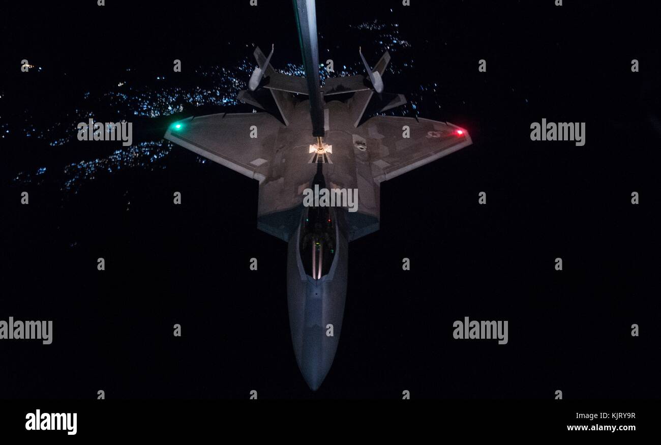 A U.S. Air Force F-22 Raptor stealth tactical fighter aircraft refuels ...