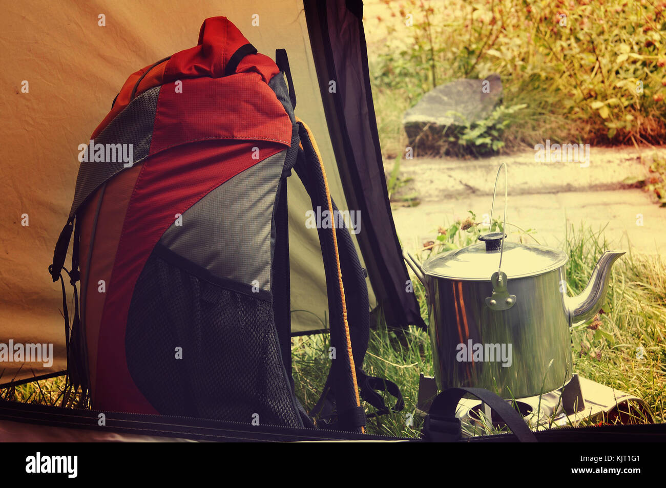 Orange backback and kettle in the tent Stock Photo - Alamy