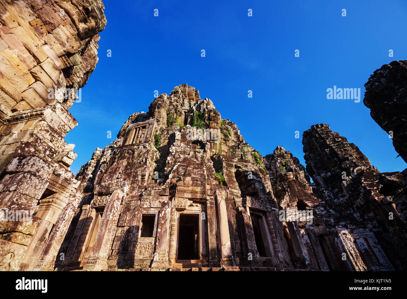 Stone faces of ancient Khmer culture temple of Bayon in Angkor area ...