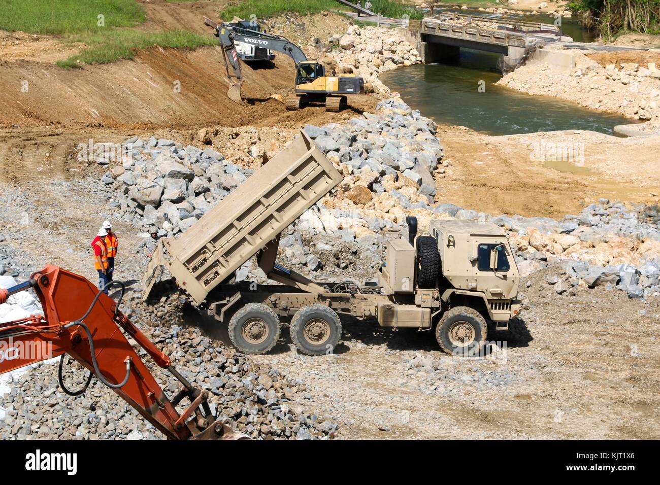 U.S. National Guard soldiers repair a fissure at the Guajataca Dam ...