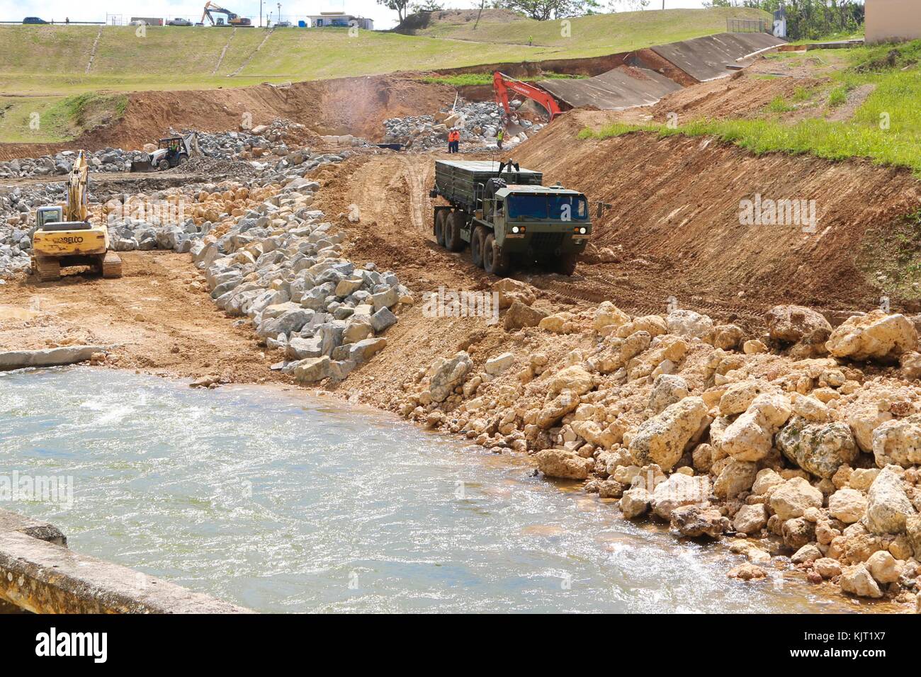 U.S. National Guard soldiers repair a fissure at the Guajataca Dam ...
