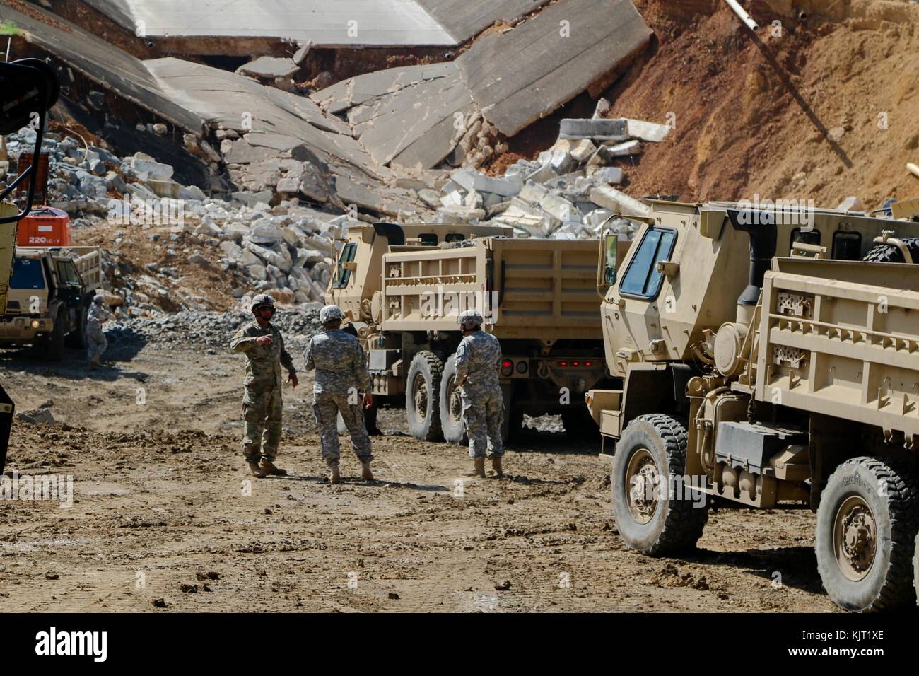 U.S. National Guard soldiers repair a fissure at the Guajataca Dam ...