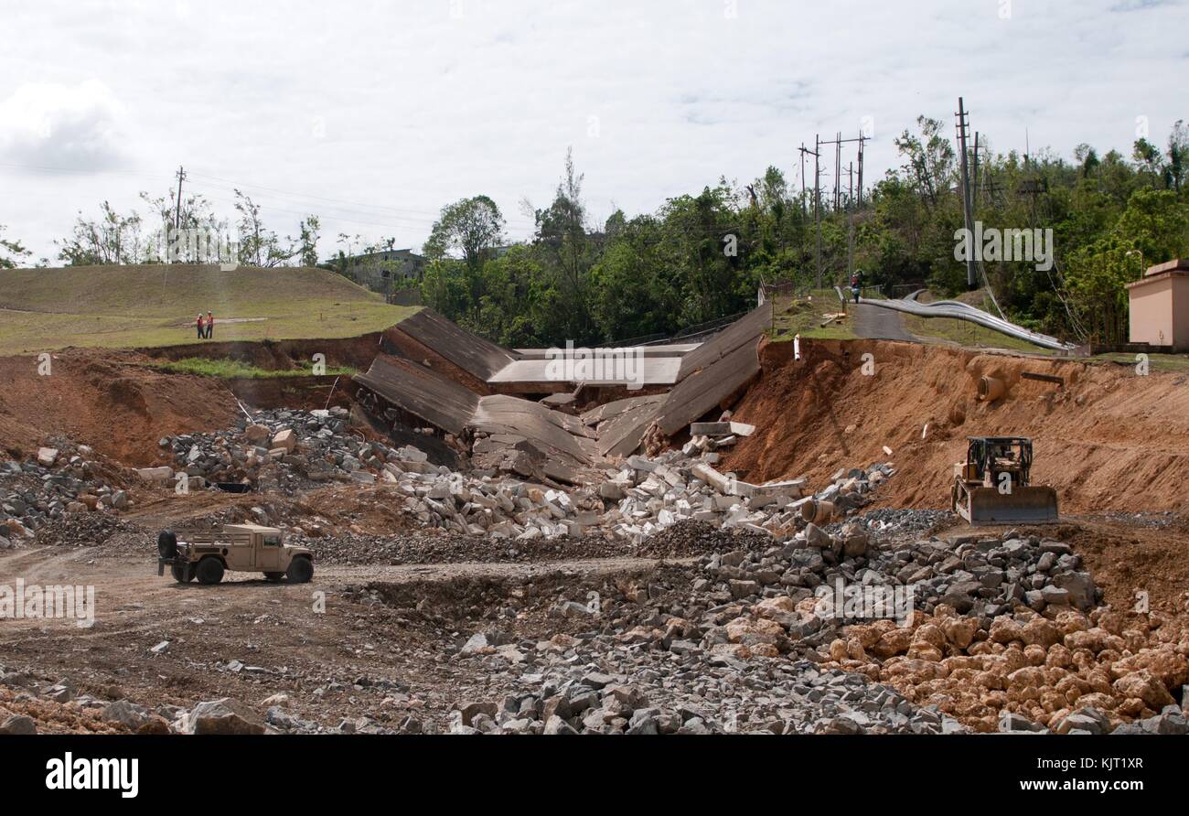 U.S. Army soldiers repair a bridge over a damaged spillway at the ...
